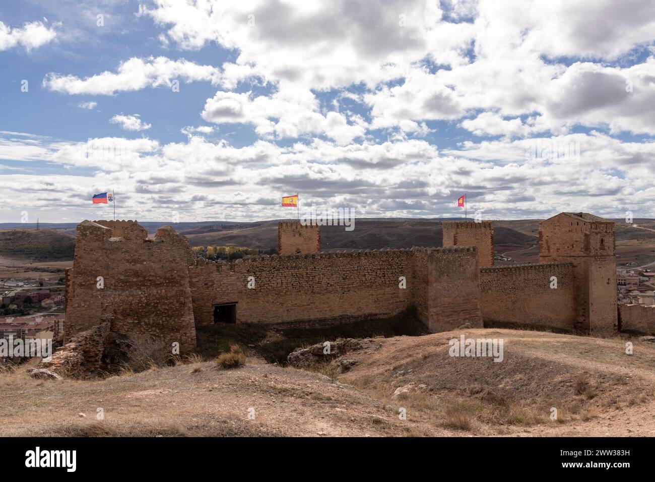 historic stone fortress with three flags on top overlooks a vast ...