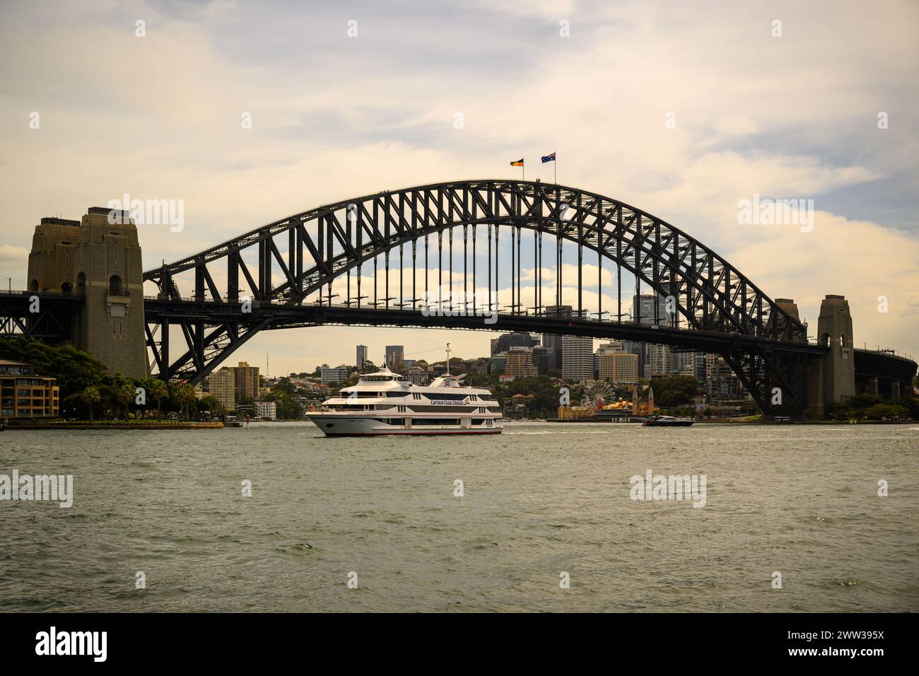 A Captain Cooke Cruises boat passing under the Sydney Harbour Bridge ...