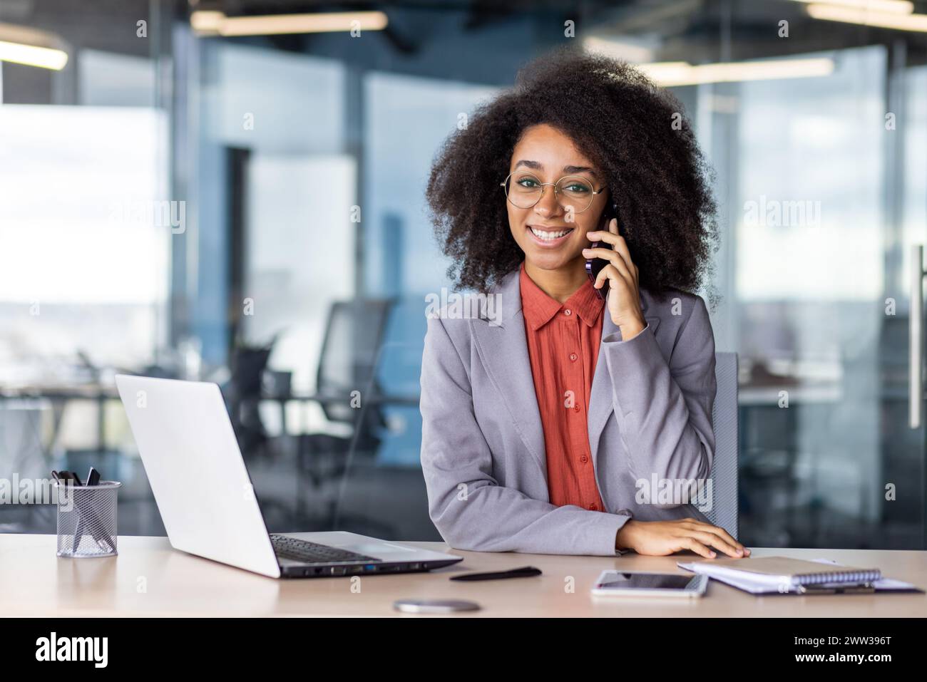 A young professional woman engages in a phone conversation at her ...