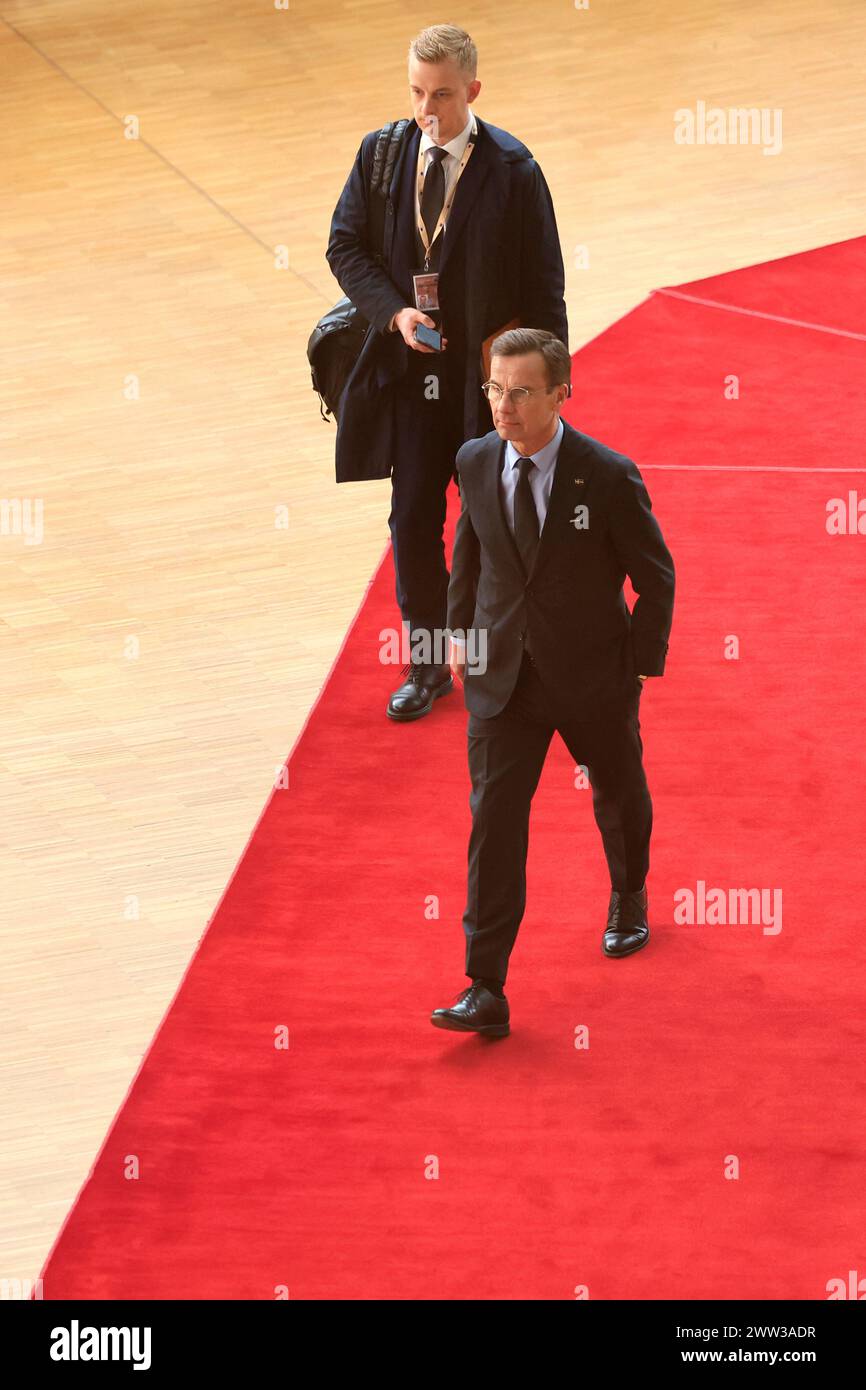 Sweden's Prime Minister Ulf Kristersson, right, arrives for a EU Summit ...