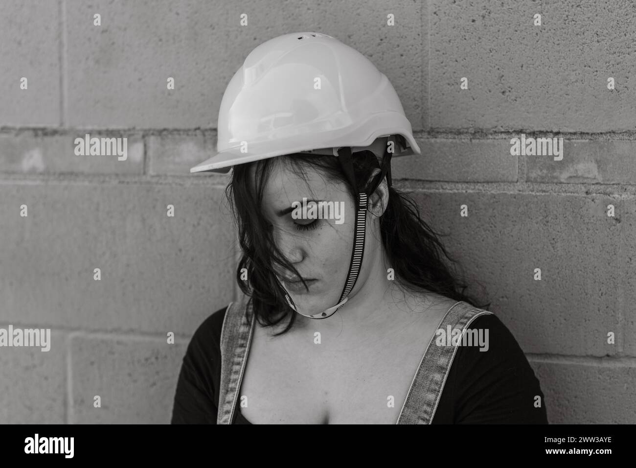 Black and white image of a contruction worker woman with a safety ...