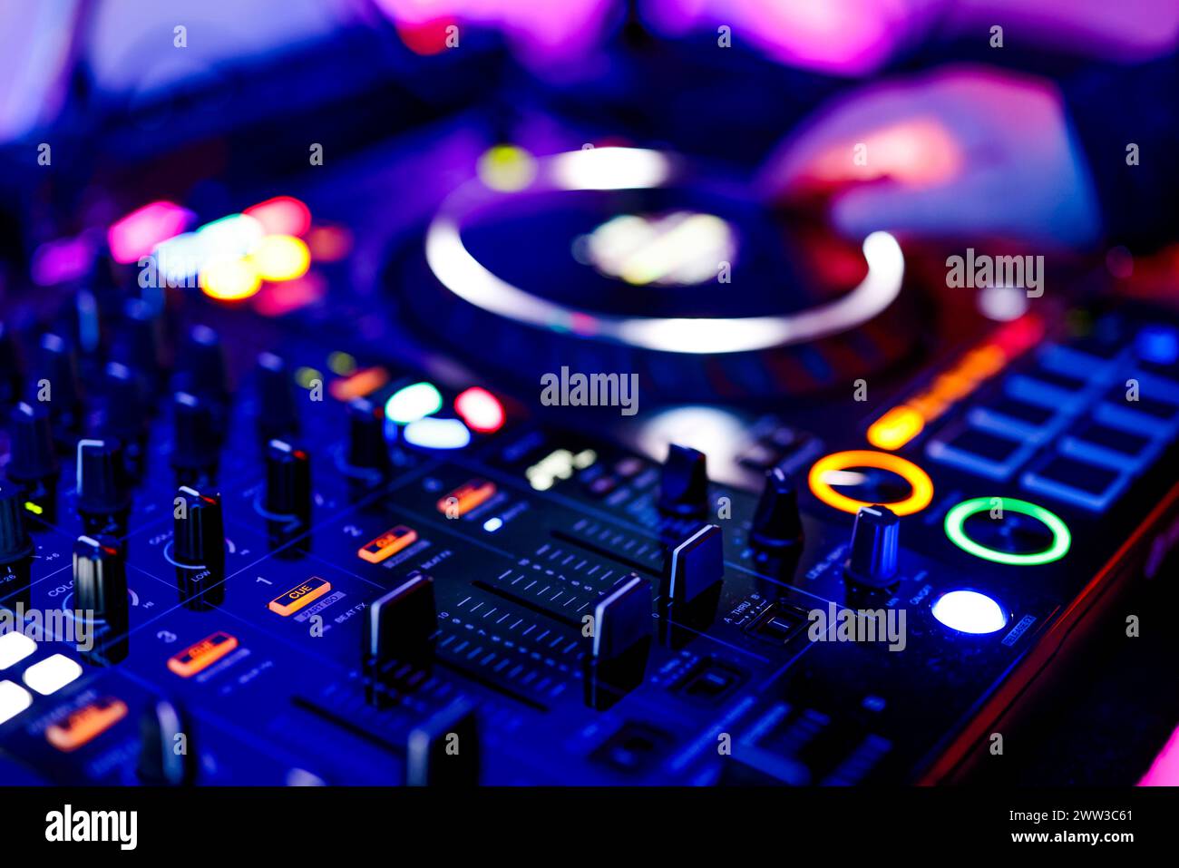 Hand of a DJ on a mixing desk, also called DJ controller or DJ console ...