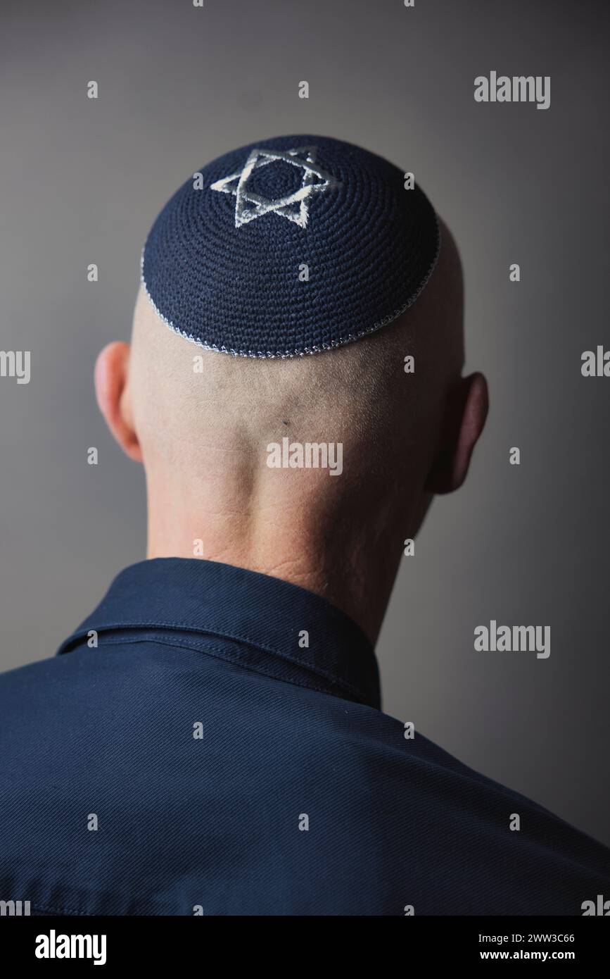 Jewish man wearing a kippa with a Star of David on his head, back view ...