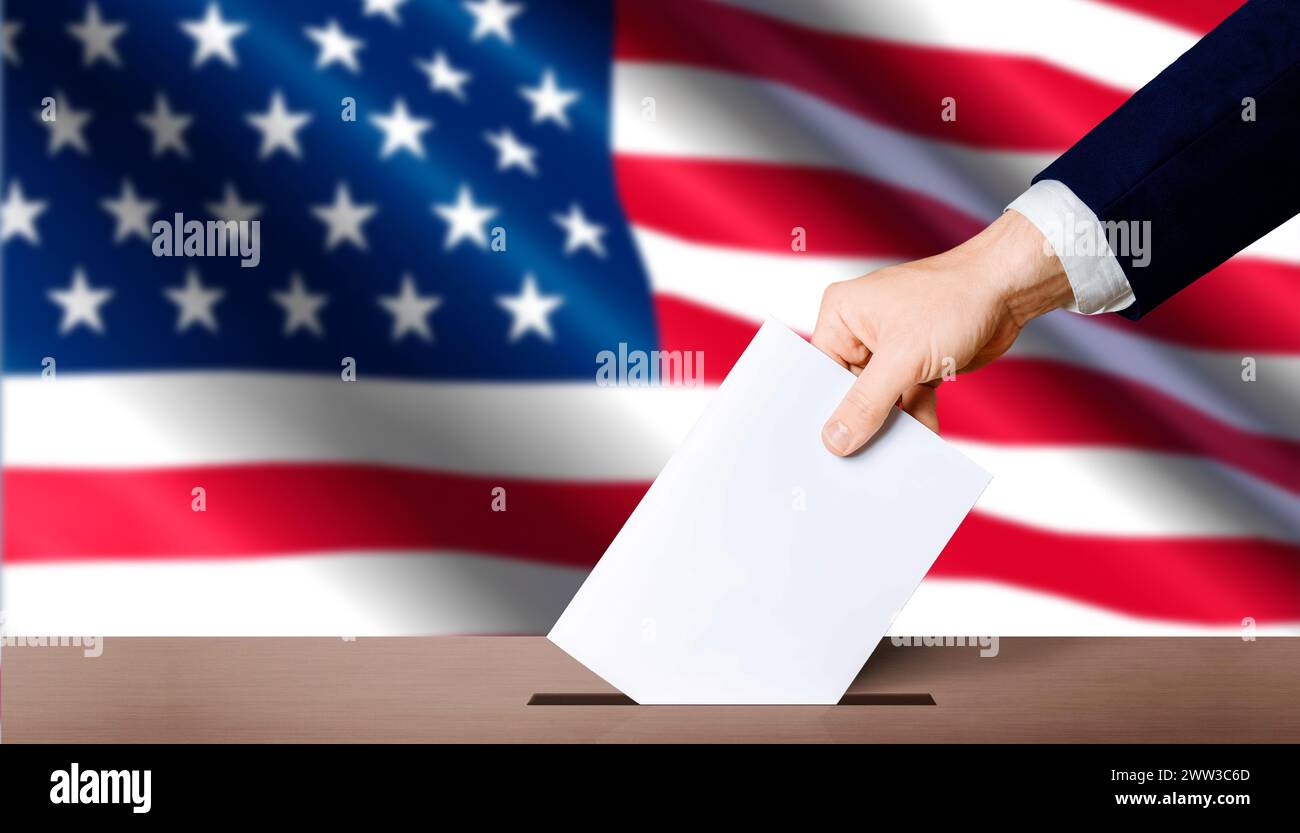 Hand holding ballot in voting ballot box with USA flag in background ...