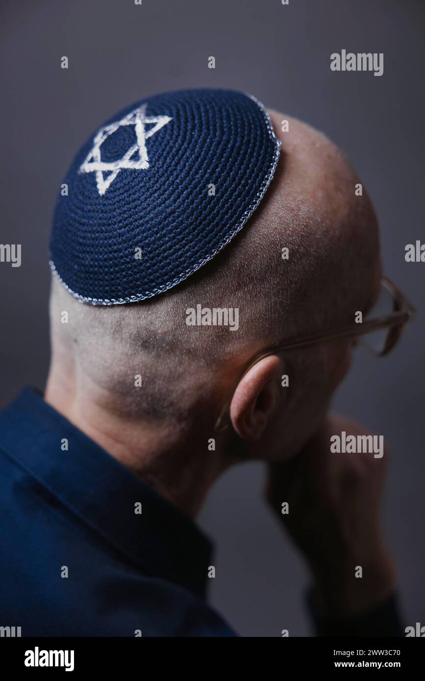 Jewish man wearing a kippa with a Star of David on his head, back view ...