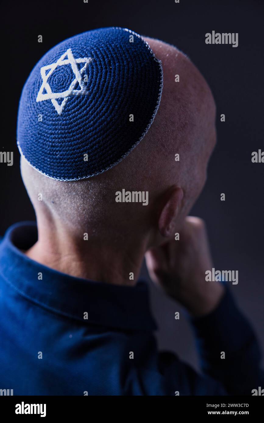 Jewish man wearing a kippa with a Star of David on his head, back view ...