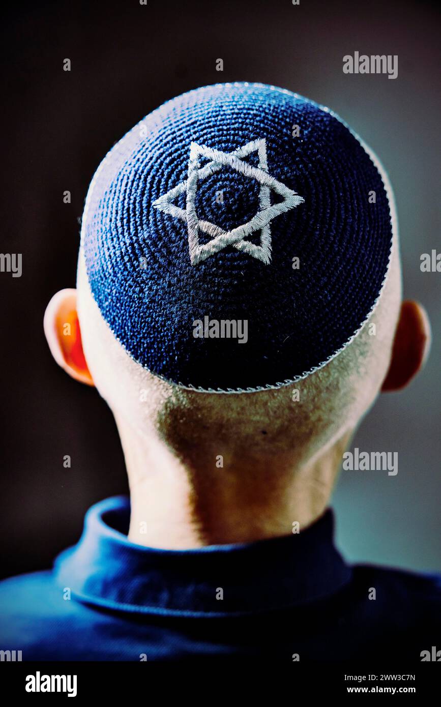 Jewish man wearing a kippa with a Star of David on his head, back view ...
