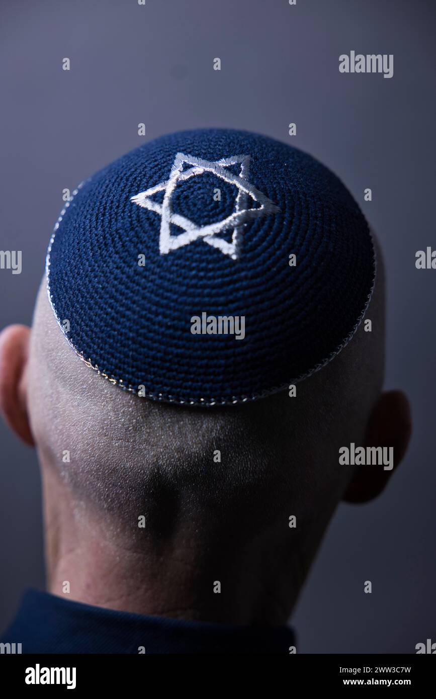 Jewish man wearing a kippa with a Star of David on his head, back view ...