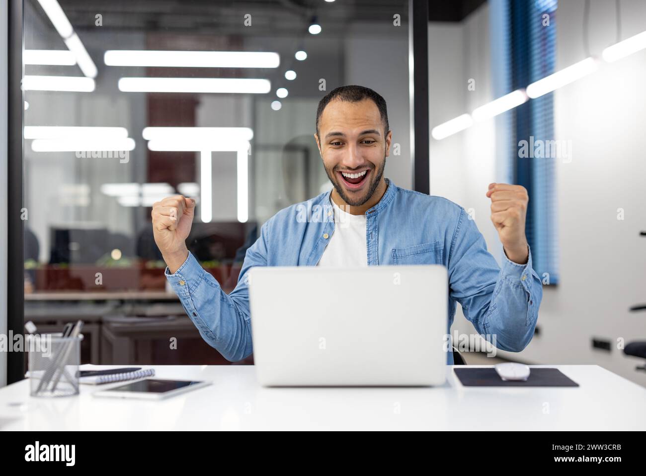 A joyous office worker celebrates a successful moment, displaying a ...
