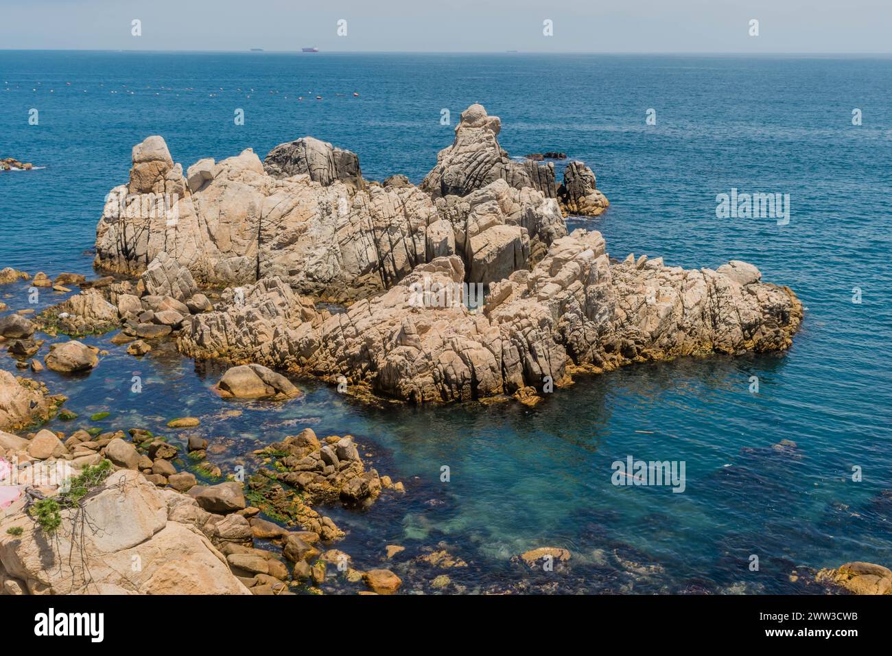 A view of a rugged coastline with clear ocean waters and rocky outcrops ...