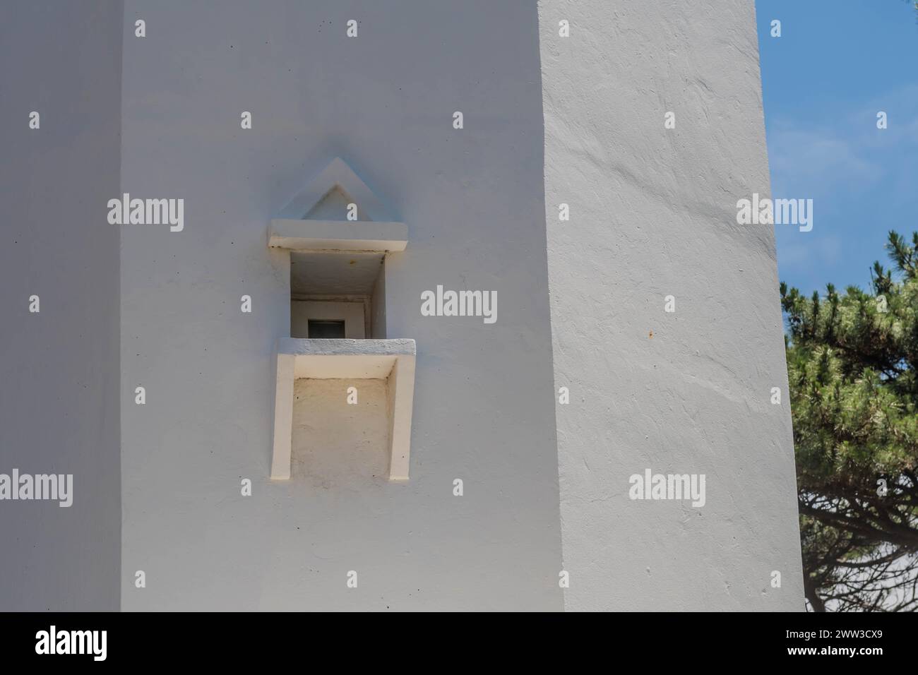 A small decorative window on the white wall of a lighthouse, in Ulsan ...