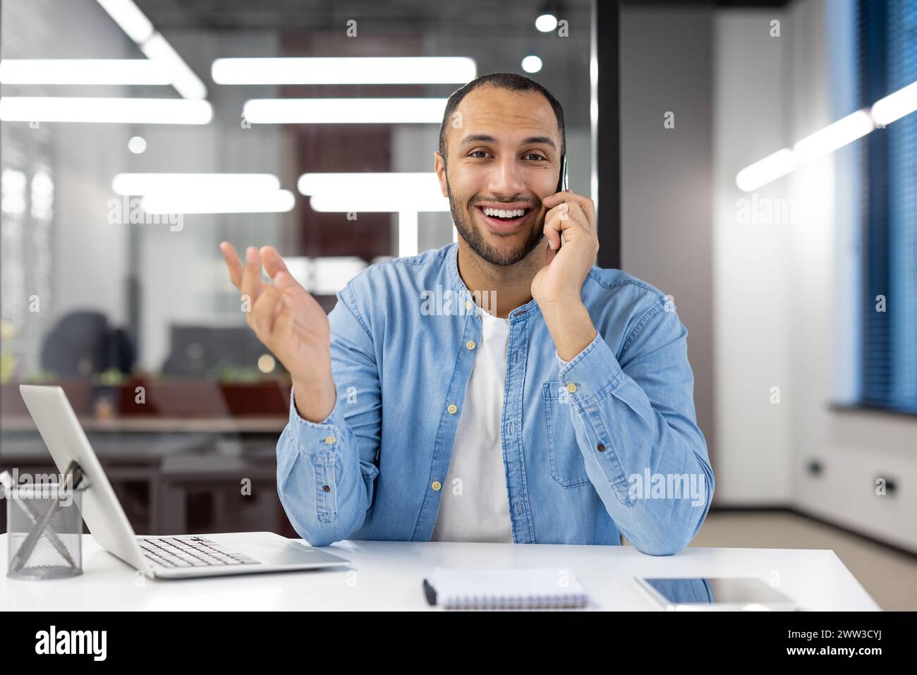 Happy male professional in a casual shirt having a pleasant ...