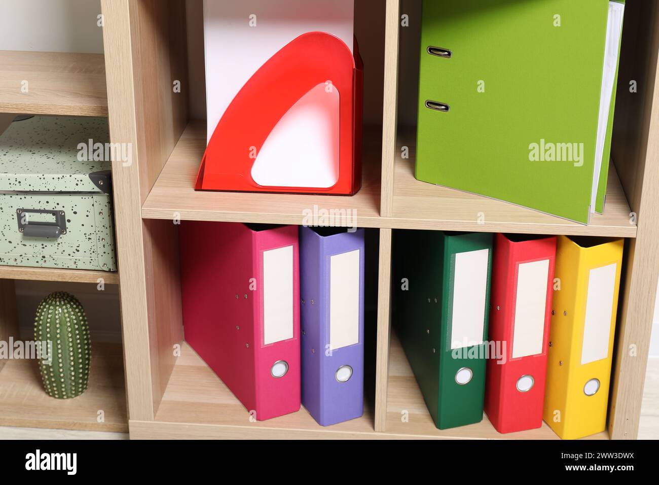 Colorful binder office folders and other stationery on shelving unit ...