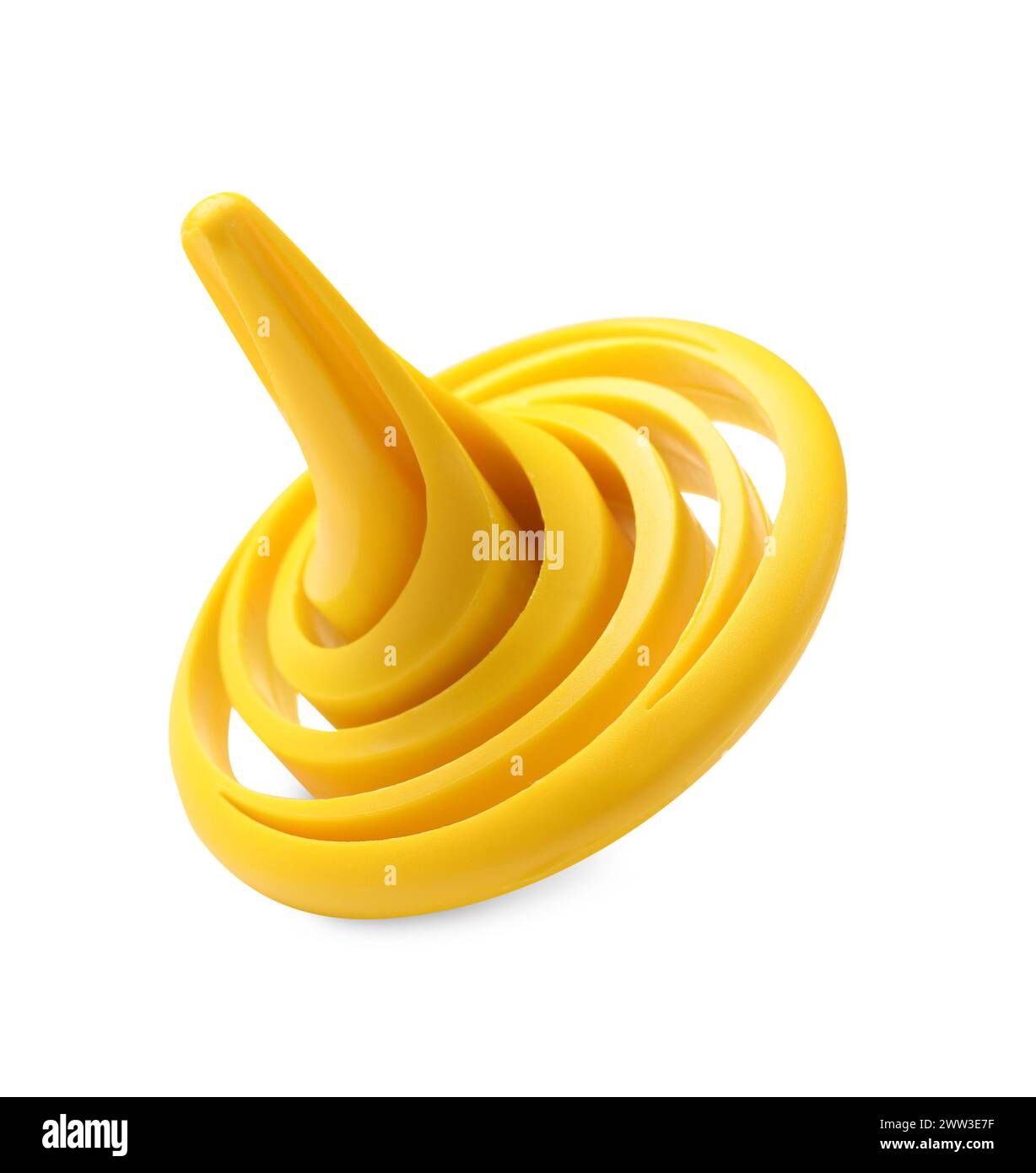 One yellow spinning top on white background Stock Photo - Alamy