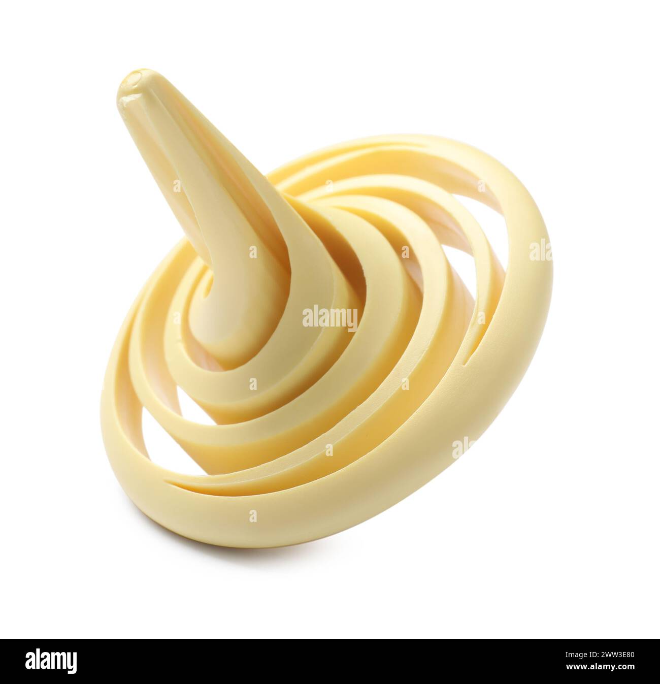 One pale yellow spinning top on white background Stock Photo - Alamy