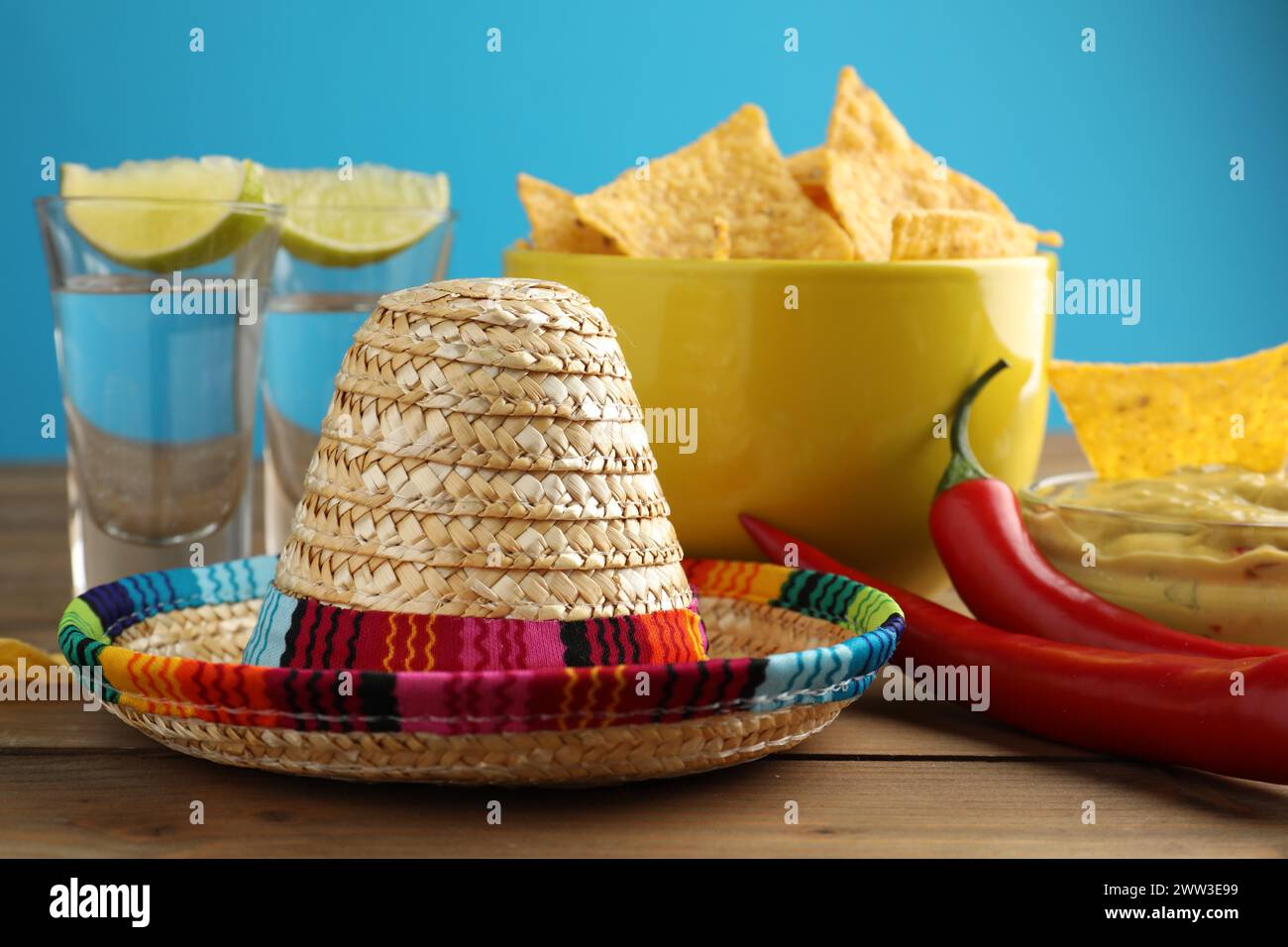 Mexican sombrero hat, tequila, chili peppers, nachos chips and ...
