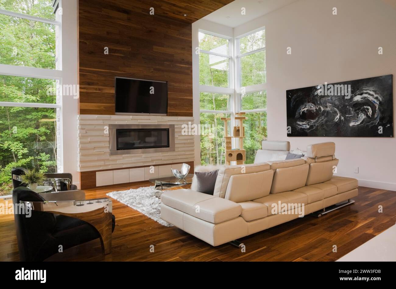 Living room with creamy beige colored L-shaped leather sofa and gas ...