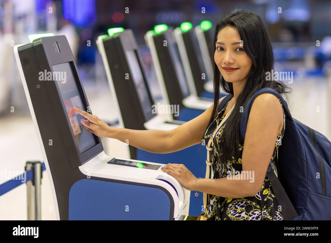Young Asian woman using self check-in kiosks in airport terminal Stock ...