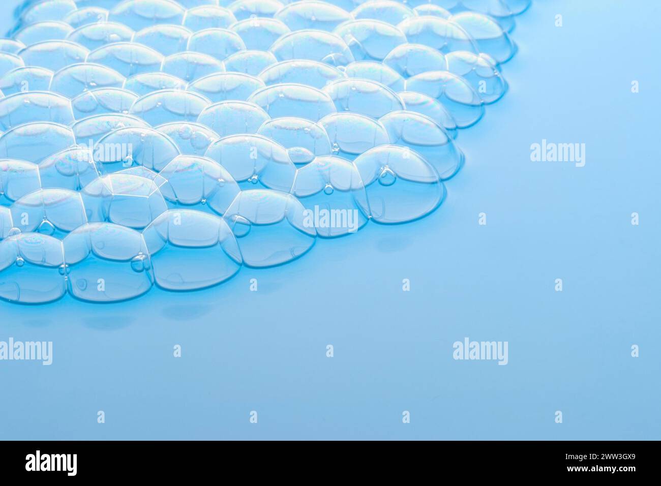 Many small soap bubbles swimmming on soft blue water surface Stock ...