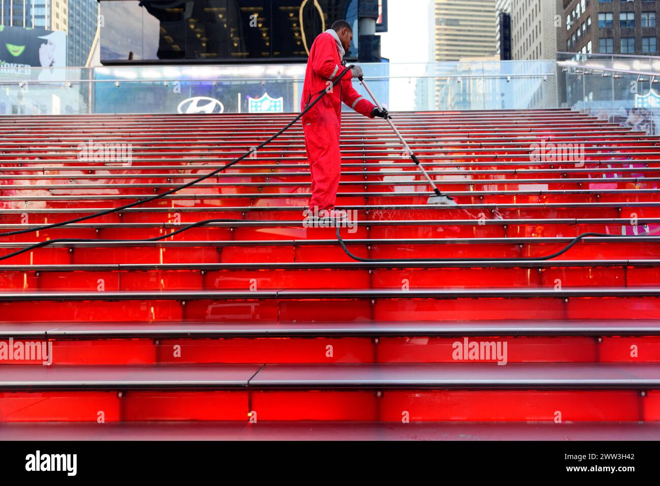 Times Square, A worker uses a hose to clean the red steps in the centre ...