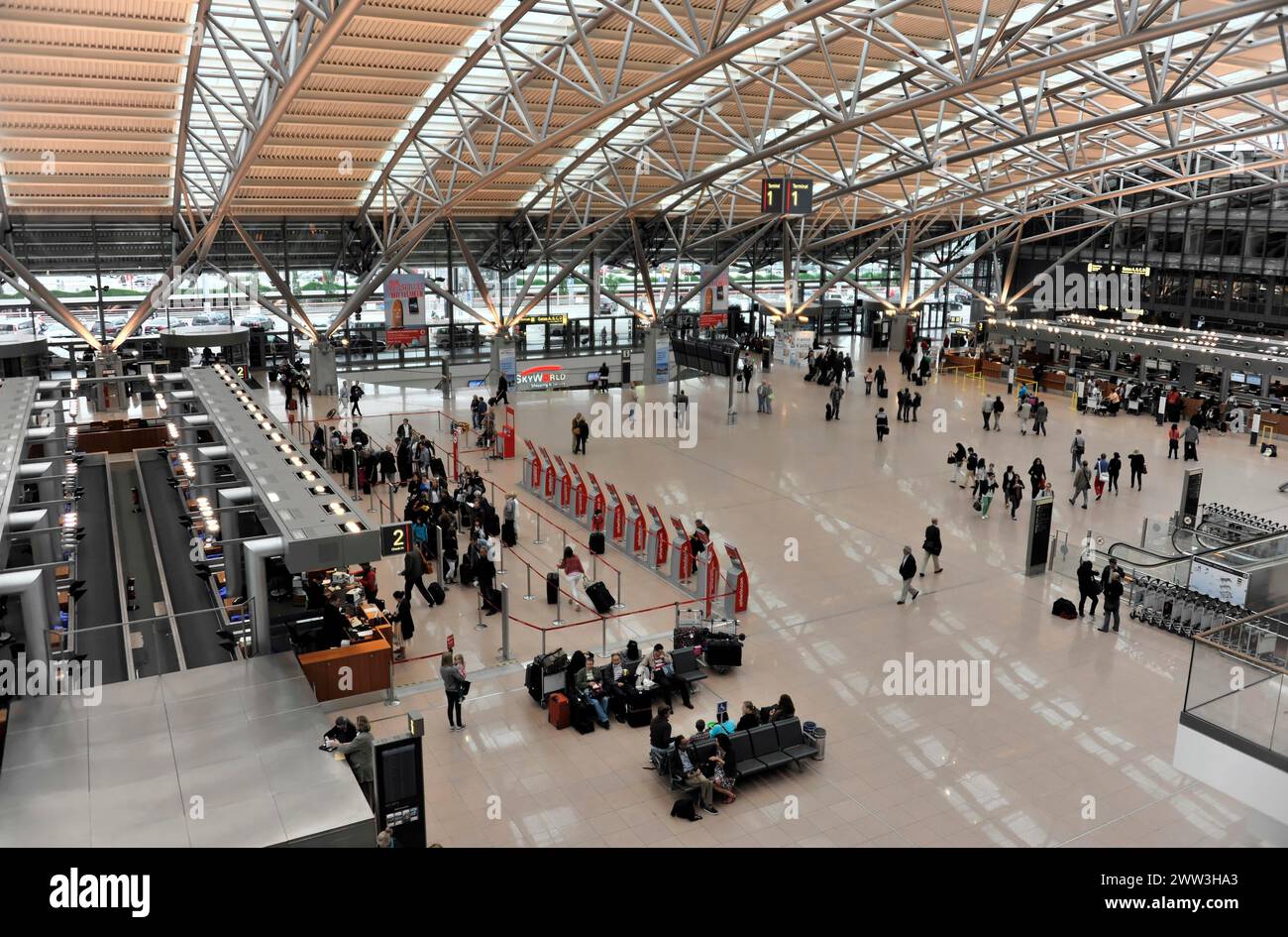 View of the interior of a busy airport terminal with passengers and ...