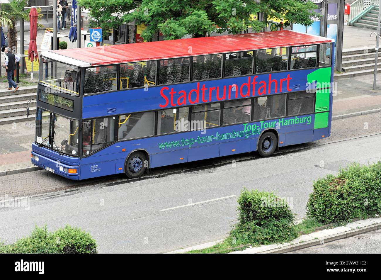 A blue sightseeing double-decker bus at a city bus stop, Hamburg ...