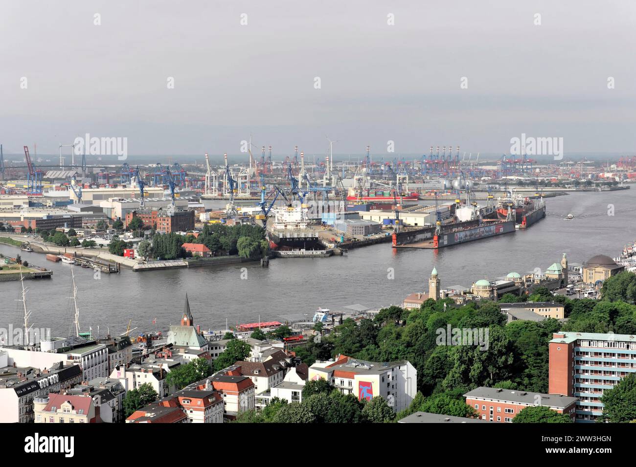 Urban skyline with river, (Elbe) harbours and scattered church towers ...