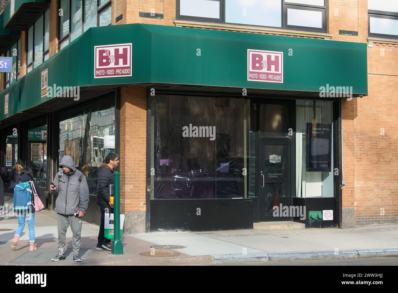 New York, NY, USA - March 21, 2024: Green and brown building of the B H store under clear sky ...