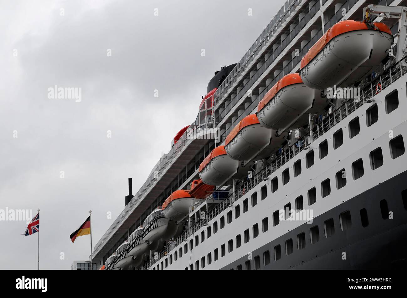 Side view of a cruise ship Queen Mary 2, with lined up lifeboats and ...
