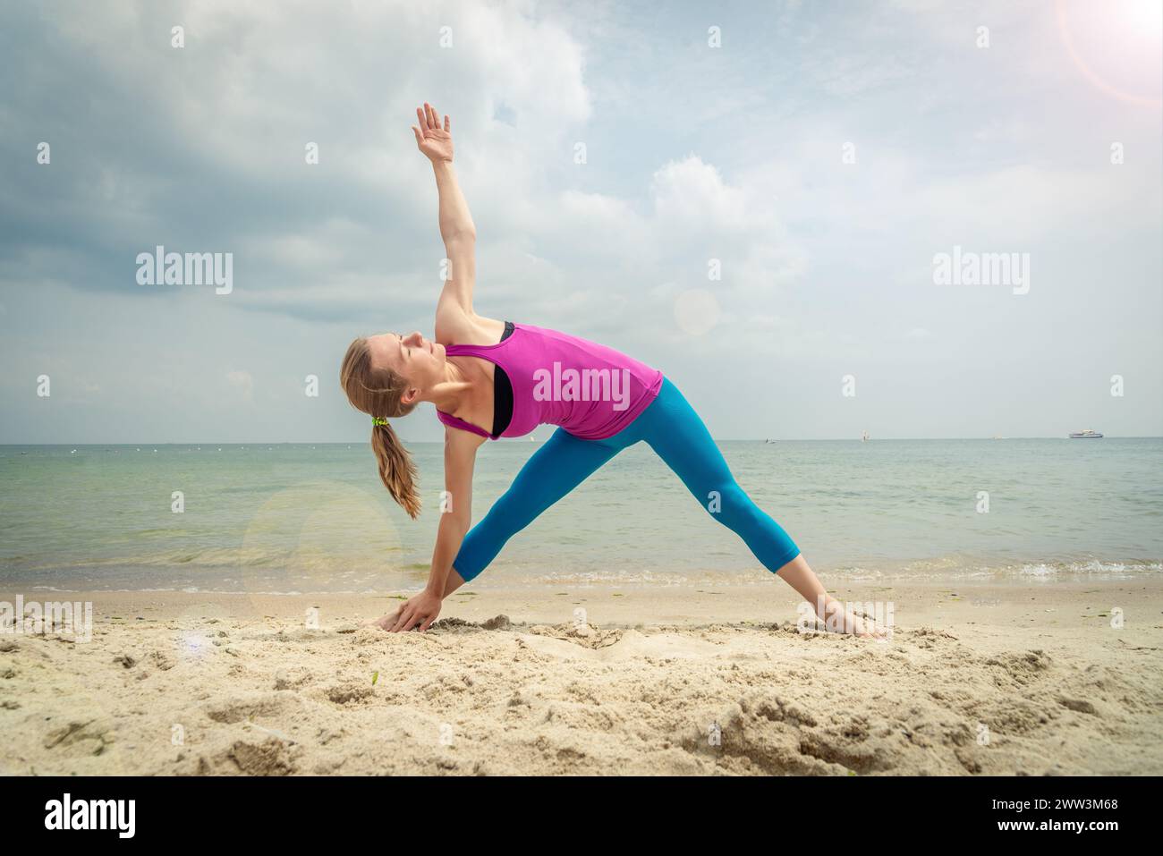 Woman practice yoga at the sea Stock Photo - Alamy