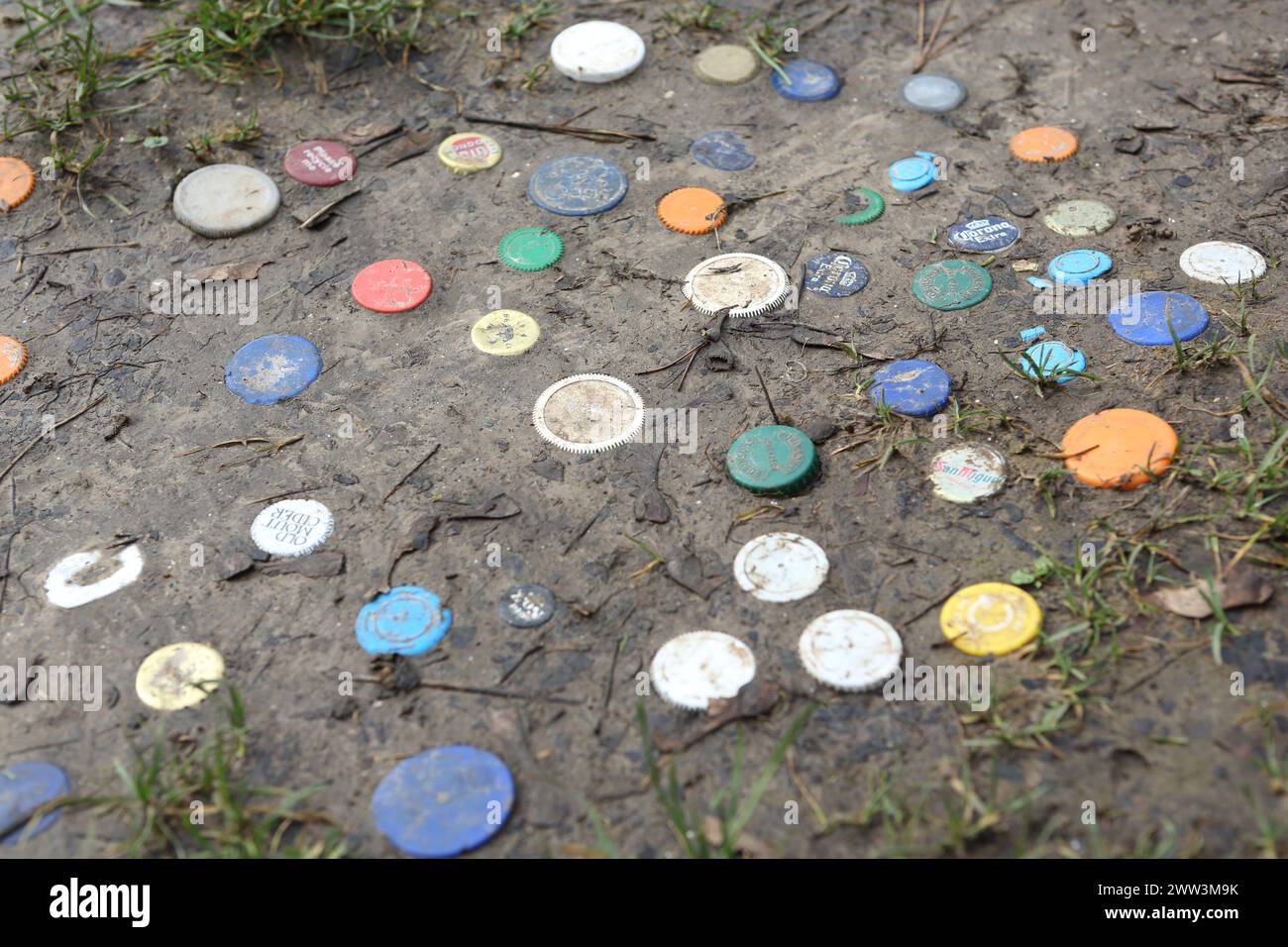 Plastic bottle tops pressed into mud and metal bottle tops Stock Photo ...