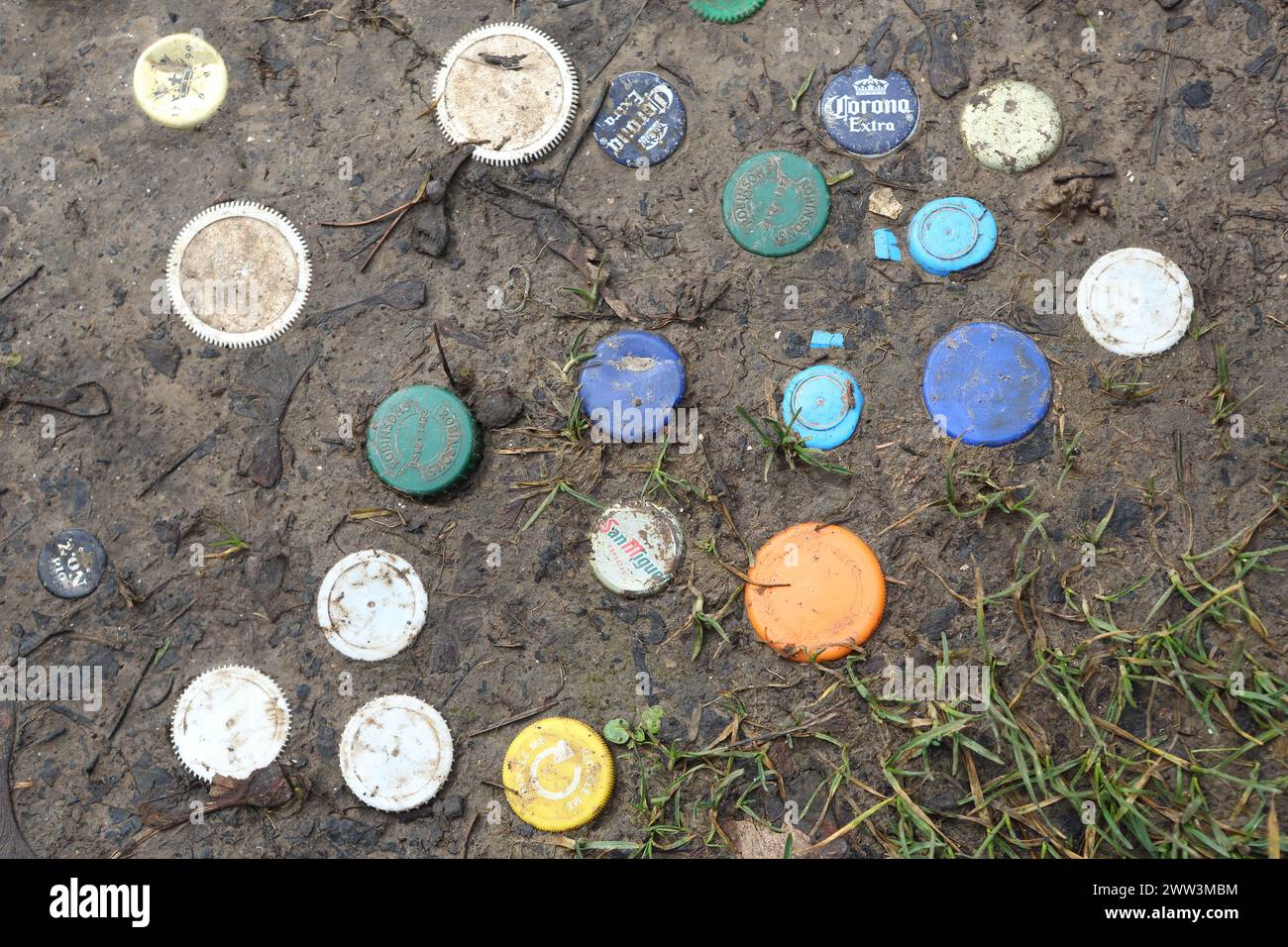 Plastic bottle tops pressed into mud and metal bottle tops Stock Photo ...