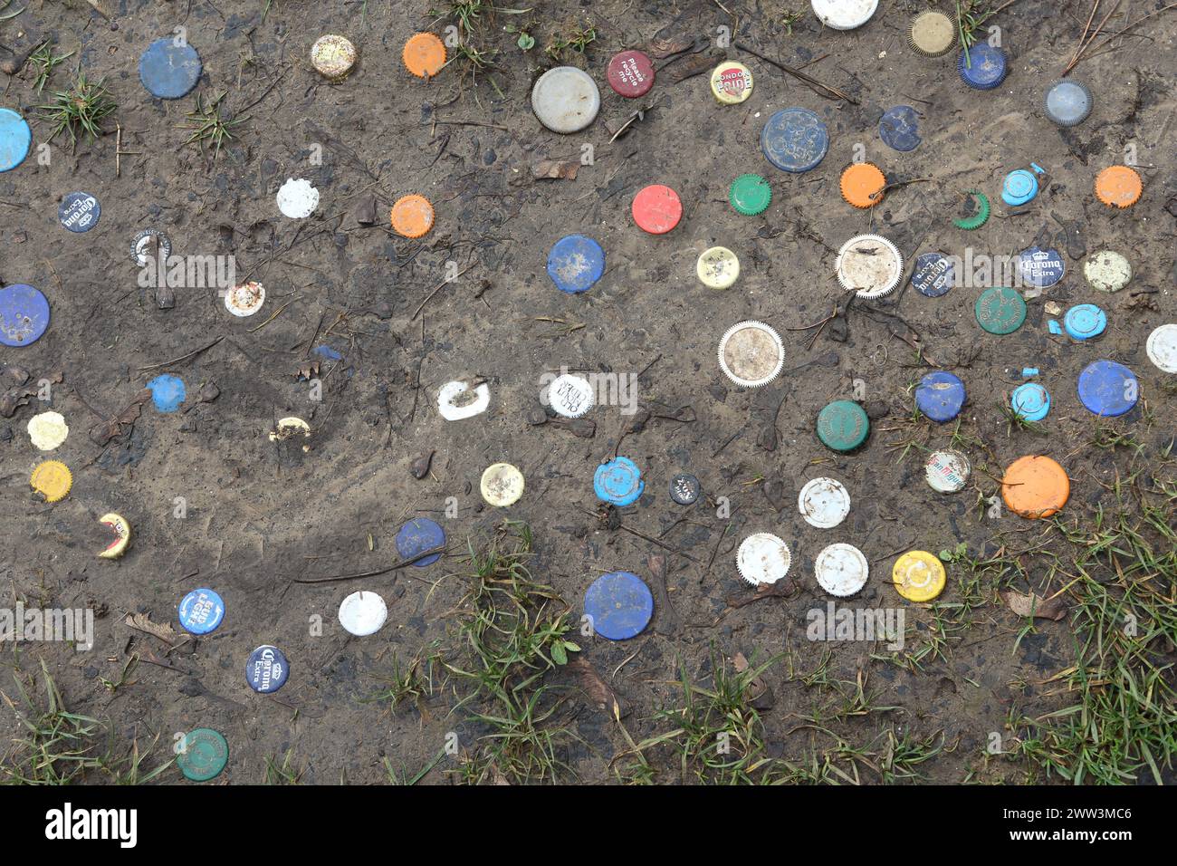 Plastic bottle tops pressed into mud and metal bottle tops Stock Photo ...