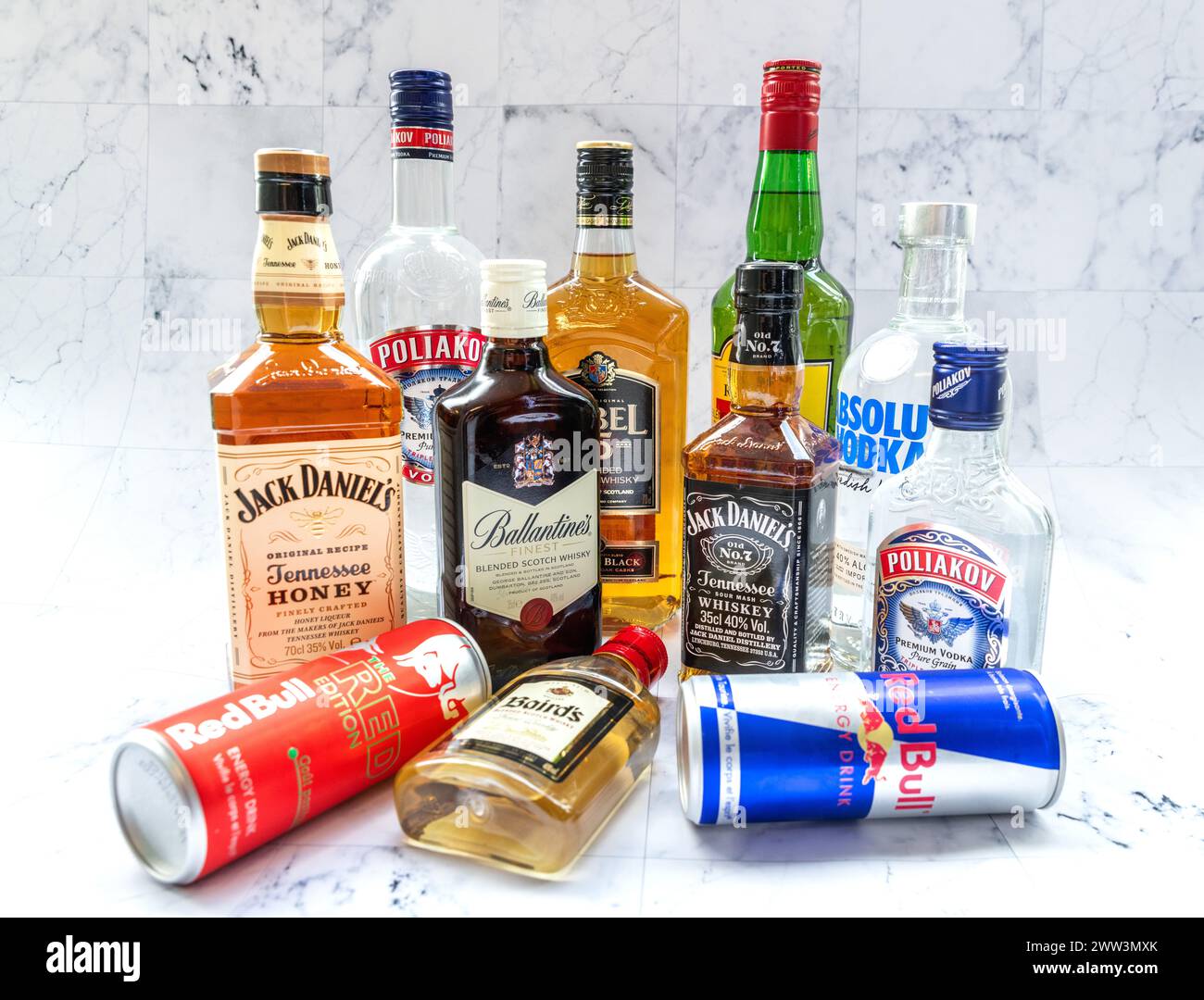 Choice of alcohol bottles on a marble tile background. Famous brands of ... Choice of alcohol bottles on a marble tile background. Famous brands of ...
