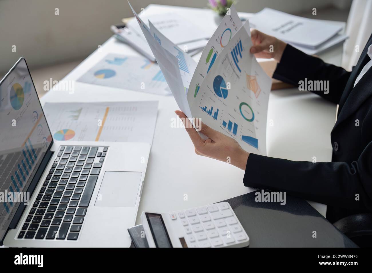 Accountant working on financial data analysis dashboard on paper as ...