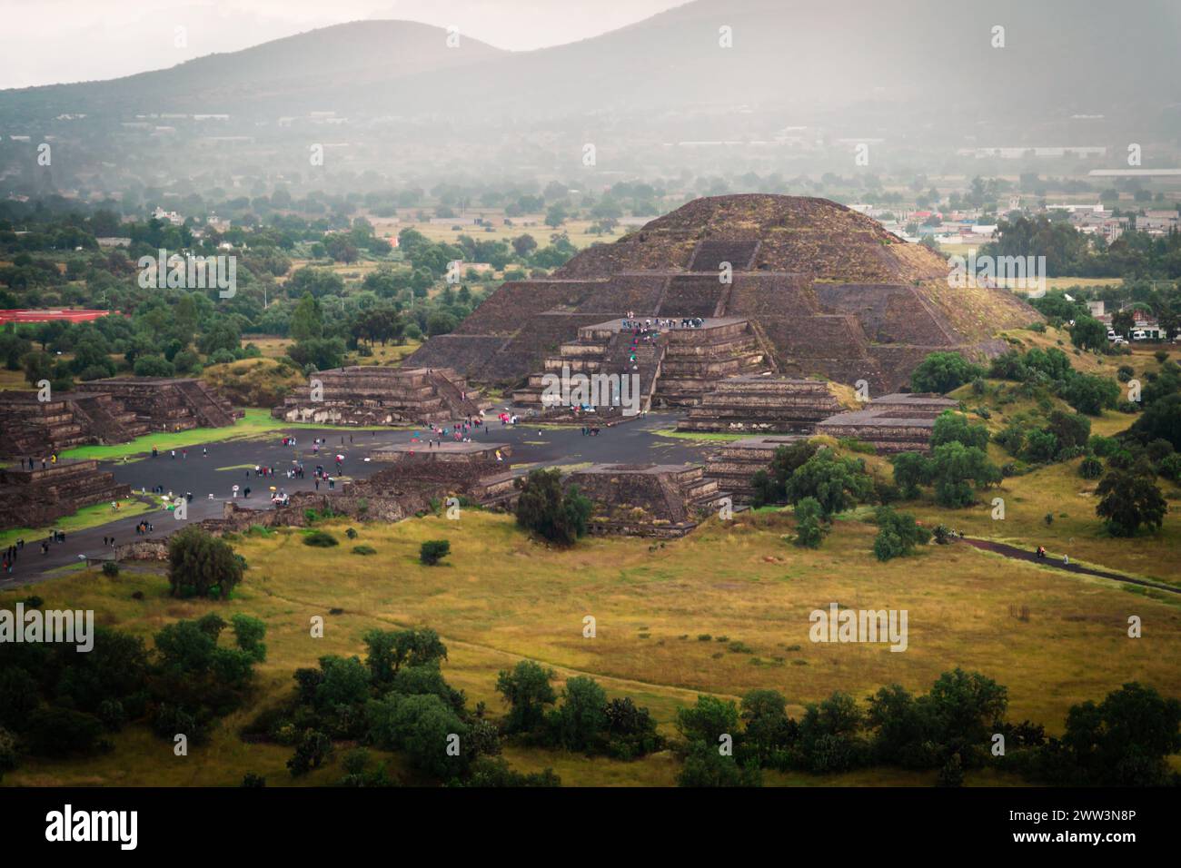 The ancient Pyramid of the Sun looming over the landscape on a hazy day ...