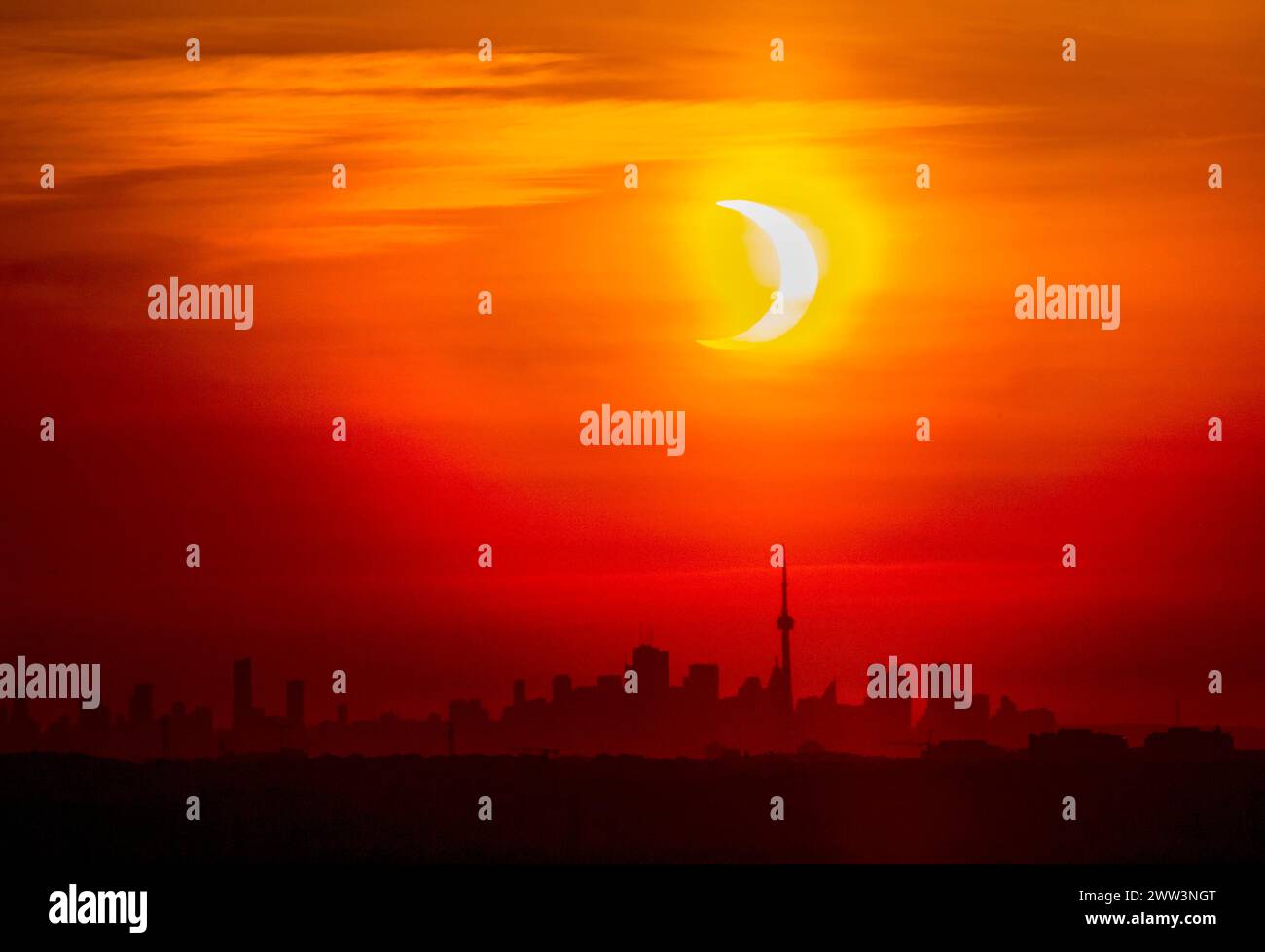 Toronto, Canada. 20th Mar, 2024. An annular solar eclipse rises over ...