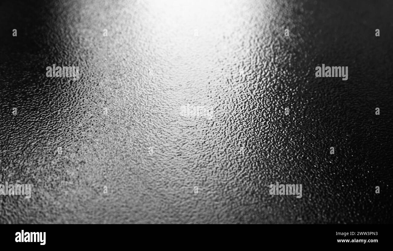 Shiny black metal palte surface, close up photo with selective focus ...