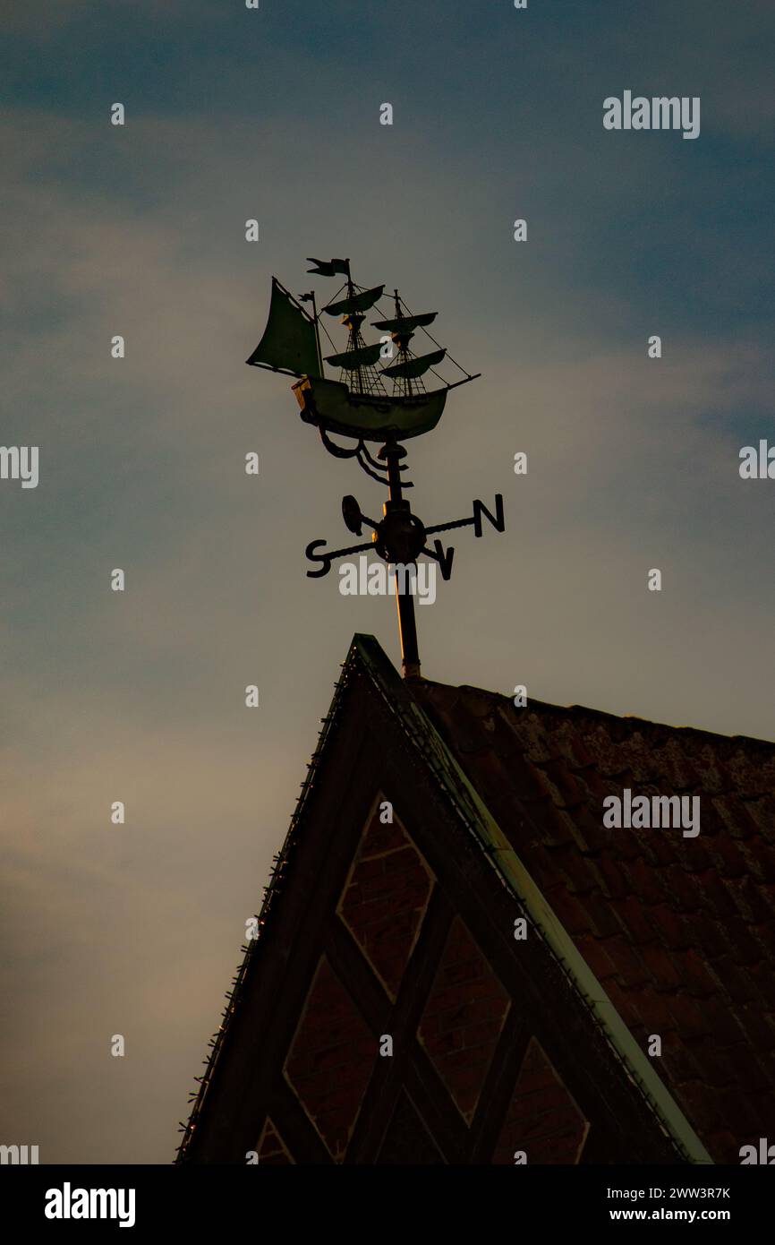Weather compass with ship decoration on rooftop Stock Photo - Alamy
