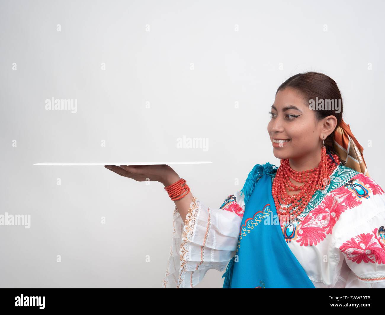 happy Hispanic woman holding a plaque ready to place an object, on the ...