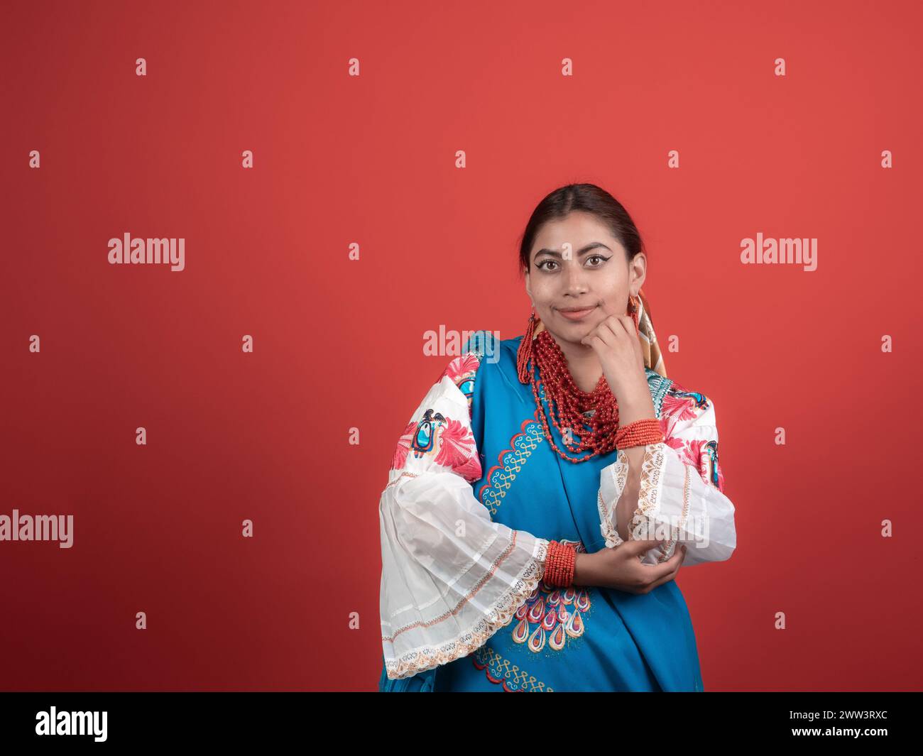 latin girl of kichwa origin happy with a red background Stock Photo - Alamy