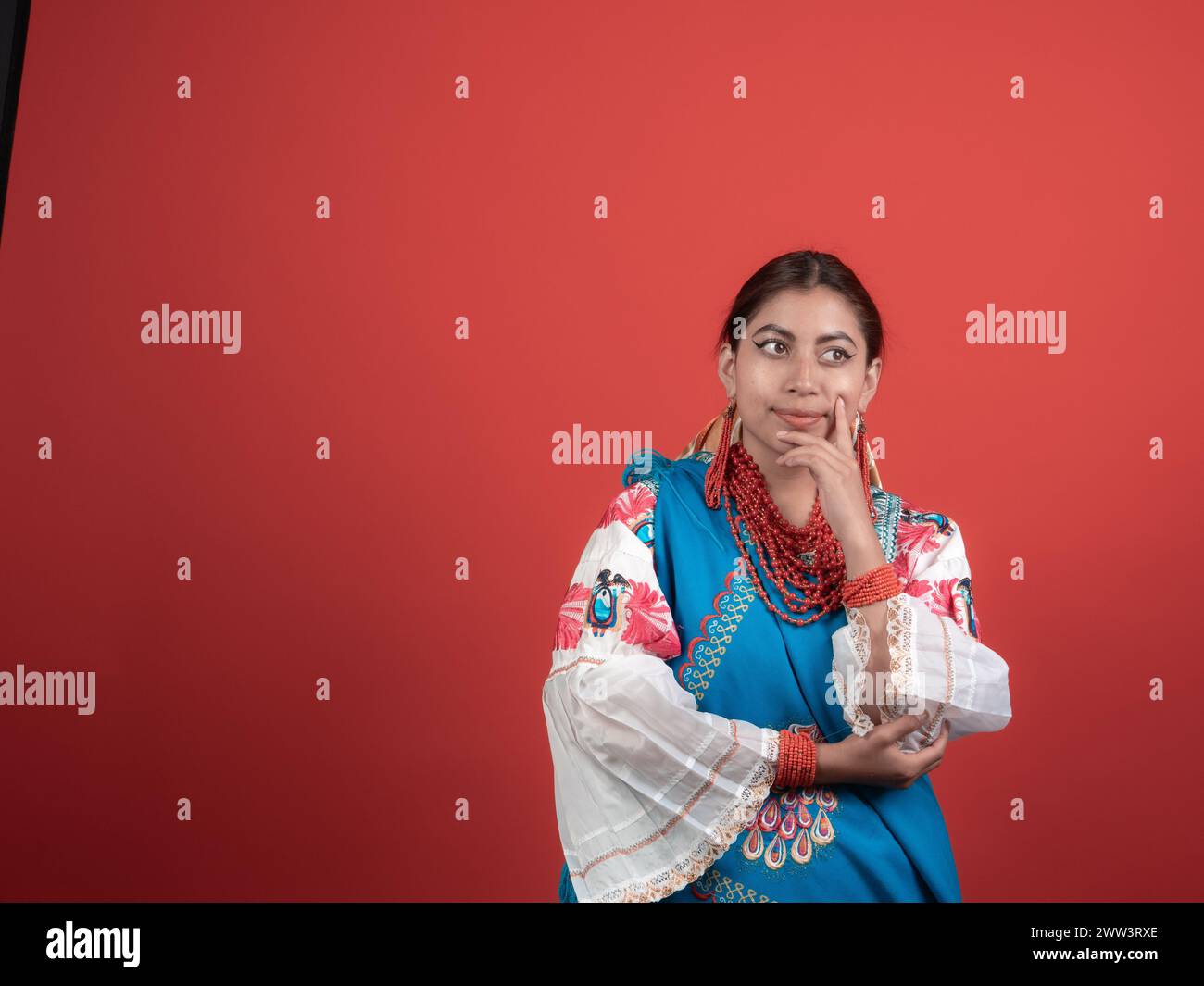 latin girl of kichwa origin with a red background and a naïve face ...