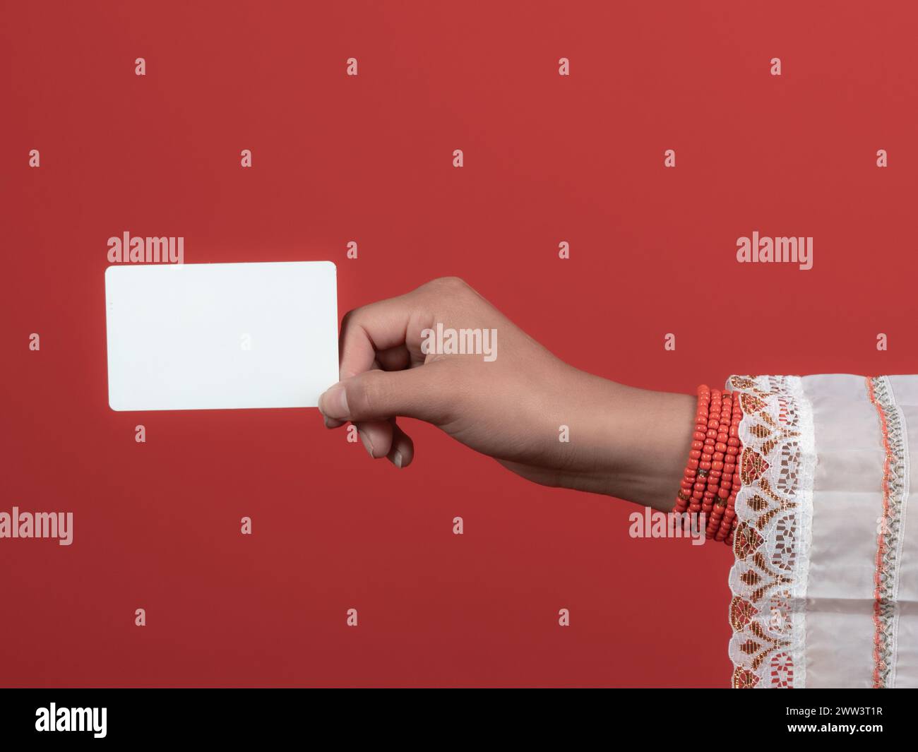 kichwa woman's hand with red handles holding a credit card with red ...