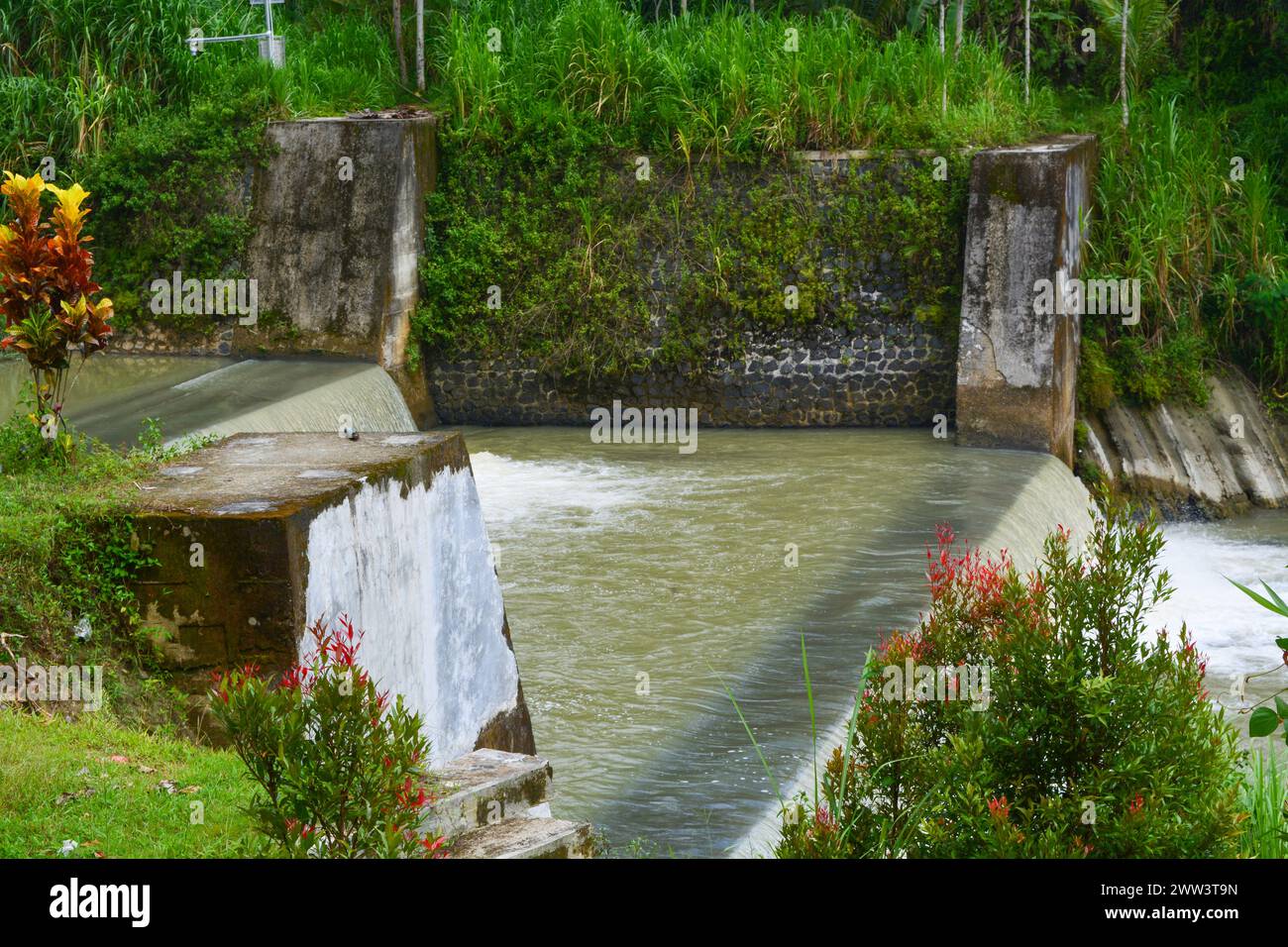 A fast-flowing stream and dramatic lenticular clouds against a dark sky ...