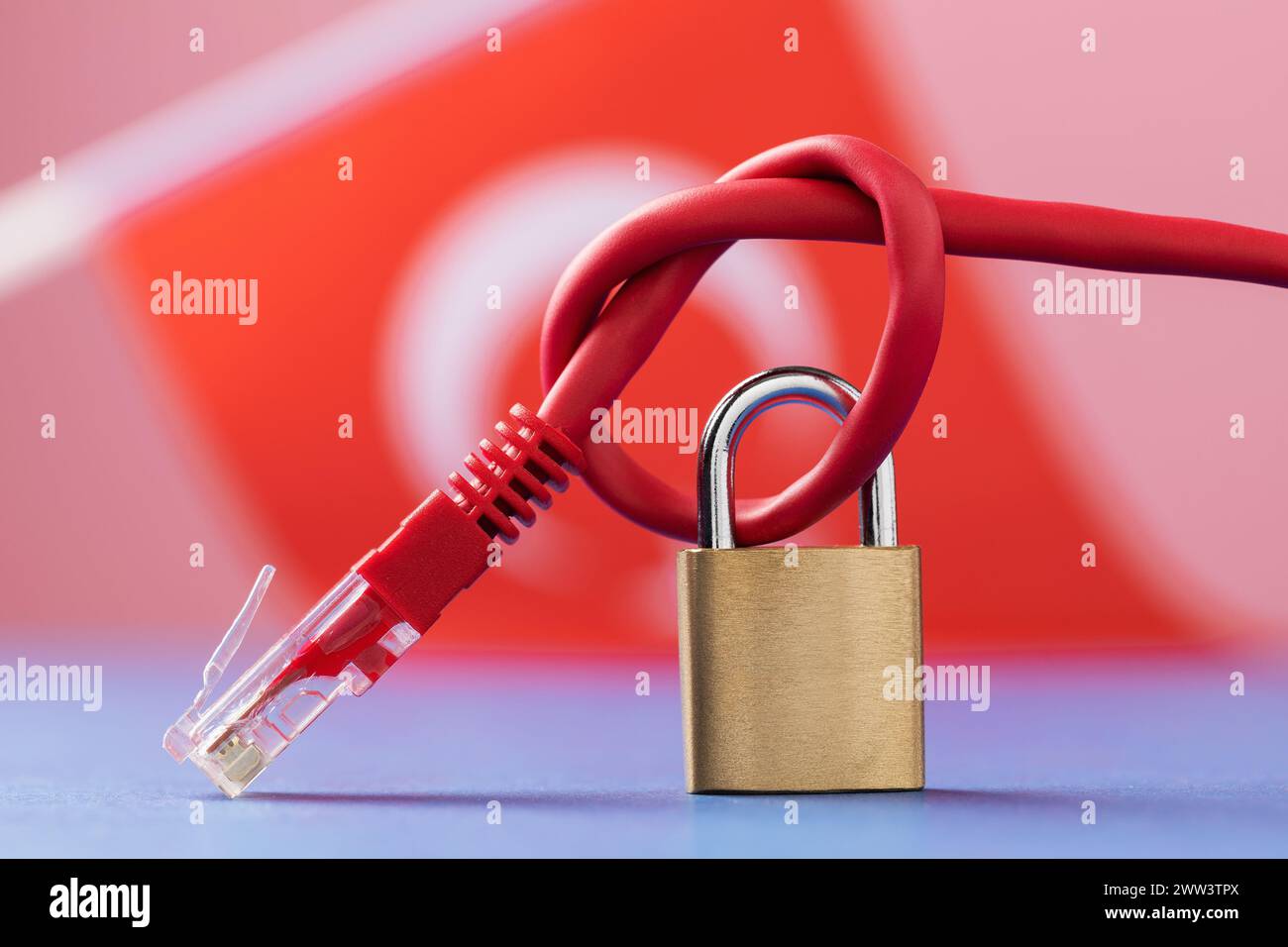 A closed lock on a tied network wire into a knot against the background ...