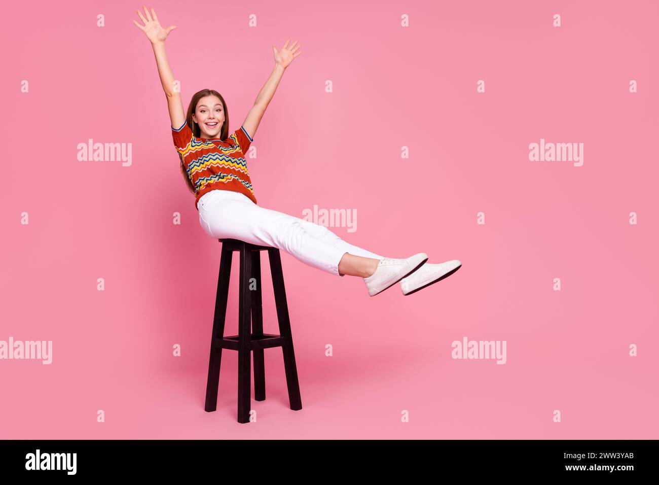 Full length portrait of overjoyed pretty girl sit stool raise arms ...
