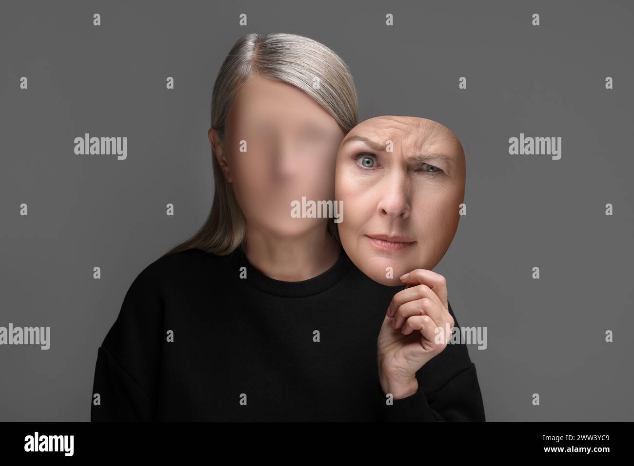 Faceless Woman Holding Her Face Mask Showing Emotion On Grey Background