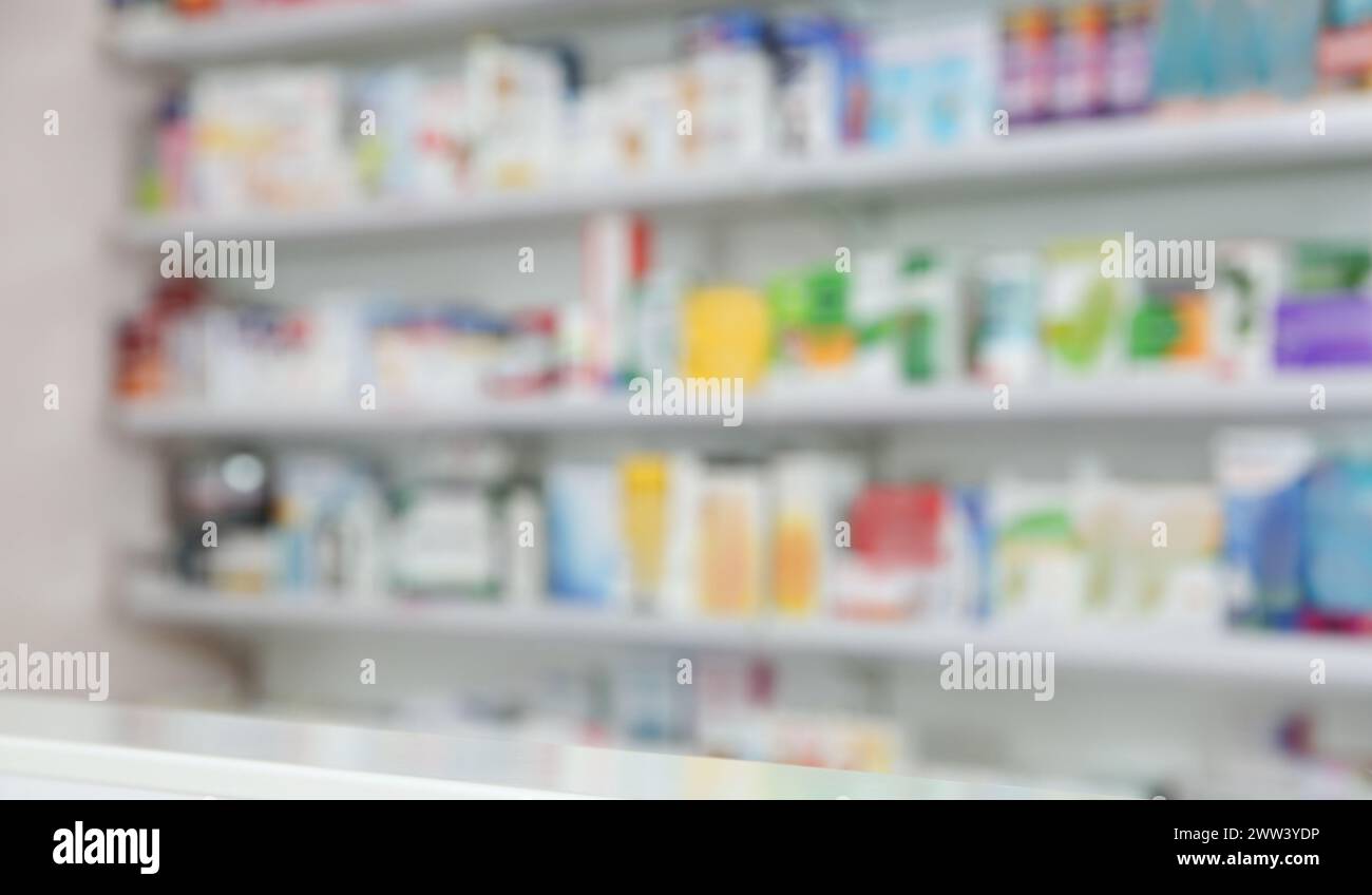 Shelves with pharmaceuticals in drugstore, blurred view. Banner design ...