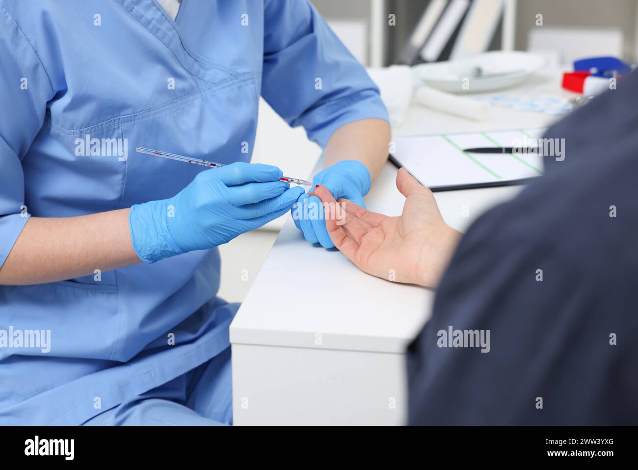 Laboratory testing. Doctor taking blood sample from patient at white ...