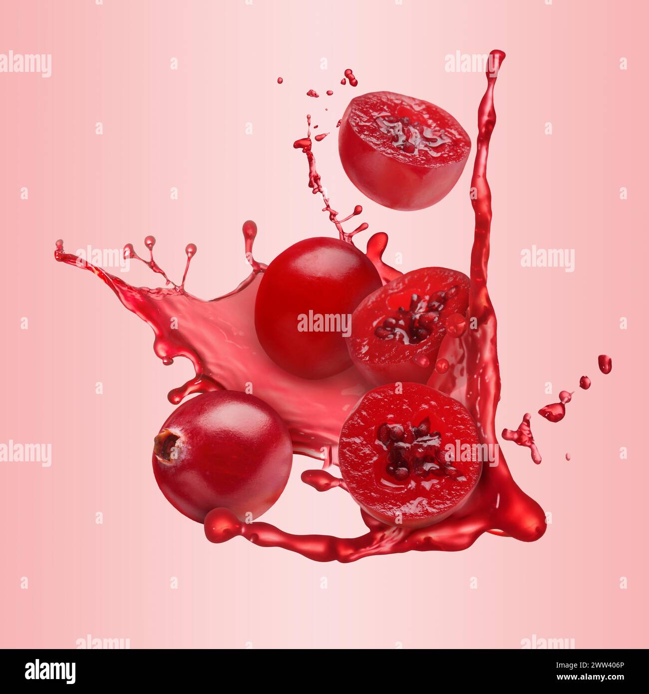 Delicious ripe cranberries and splashing juice in air on pale red ...